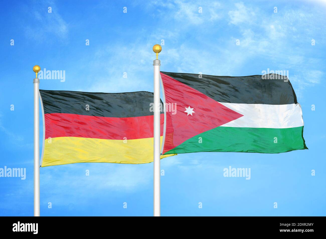 Germany and Jordan two flags on flagpoles and blue cloudy sky Stock ...