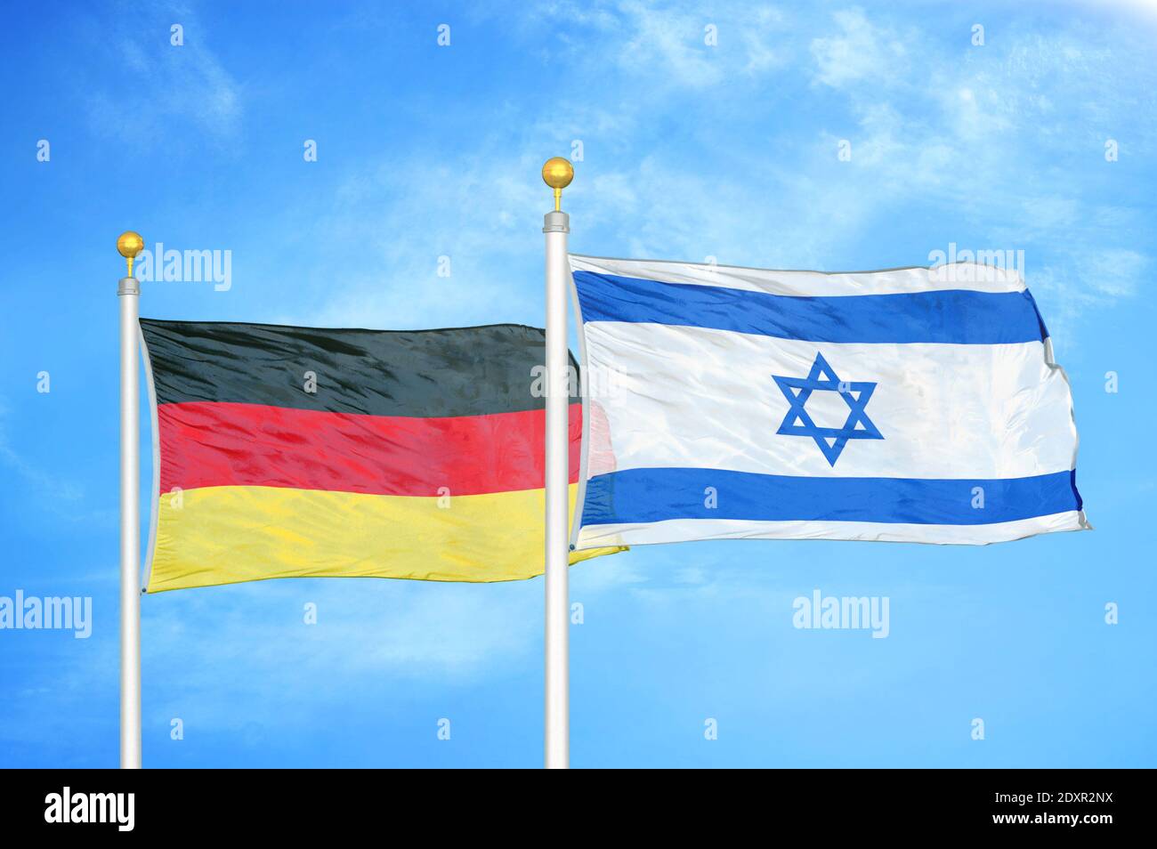 Germany and Israel two flags on flagpoles and blue cloudy sky Stock ...