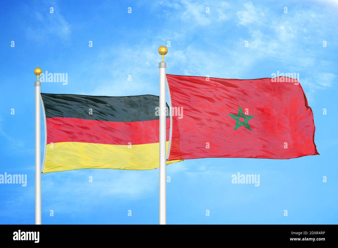 Germany and Morocco two flags on flagpoles and blue cloudy sky Stock ...