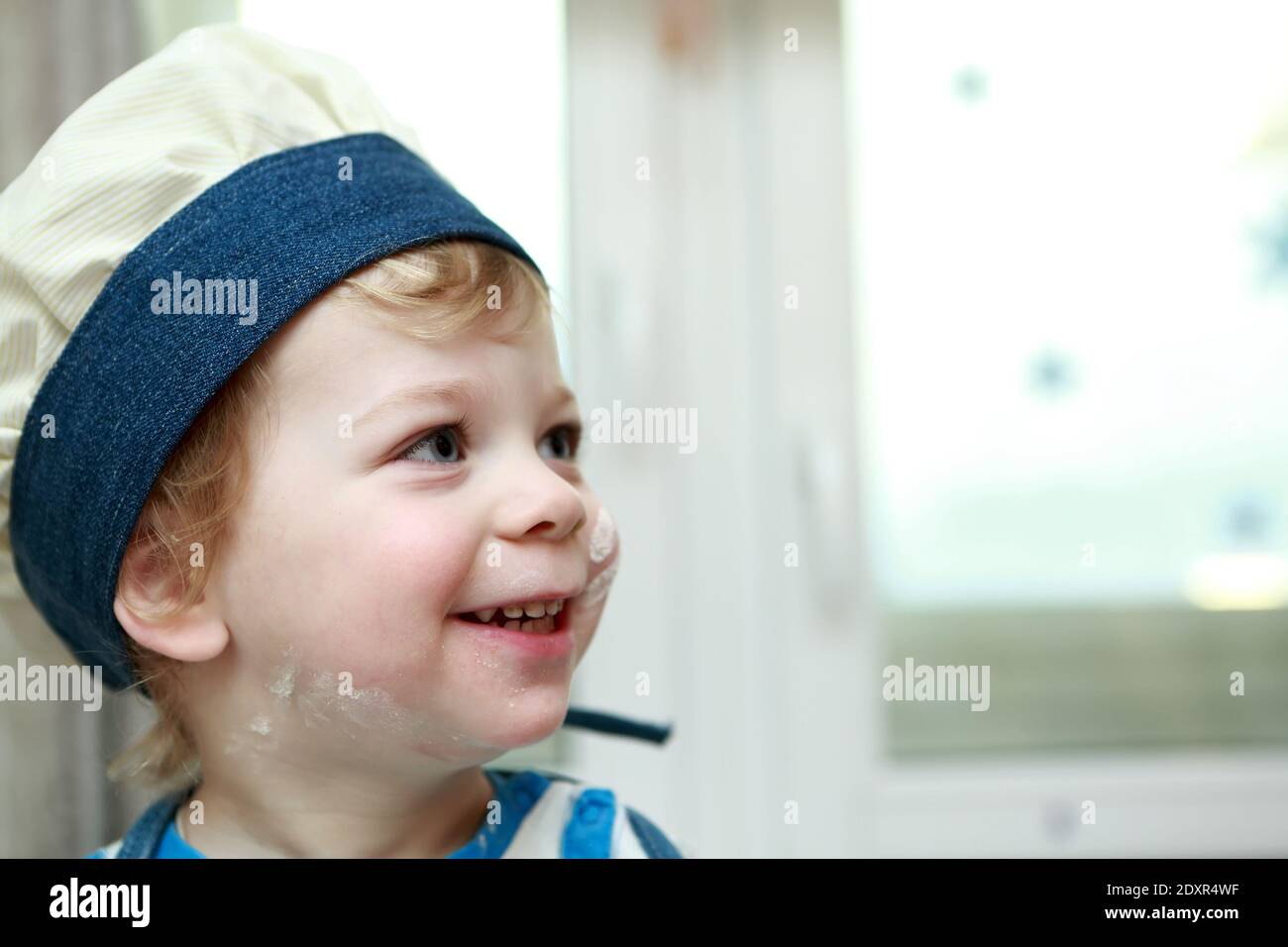 Portrait of a smiling cook kid in kitchen Stock Photo - Alamy