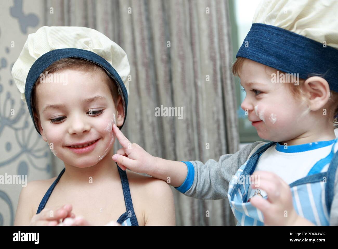 Children playing in a kitchen at home Stock Photo - Alamy