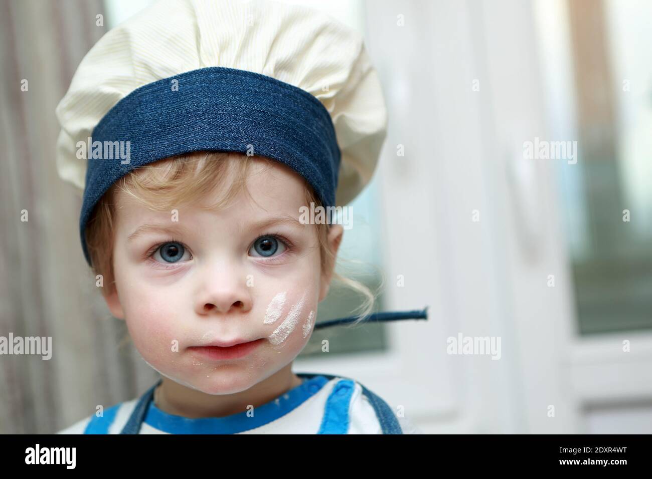 Portrait of a serious cook boy in kitchen Stock Photo - Alamy