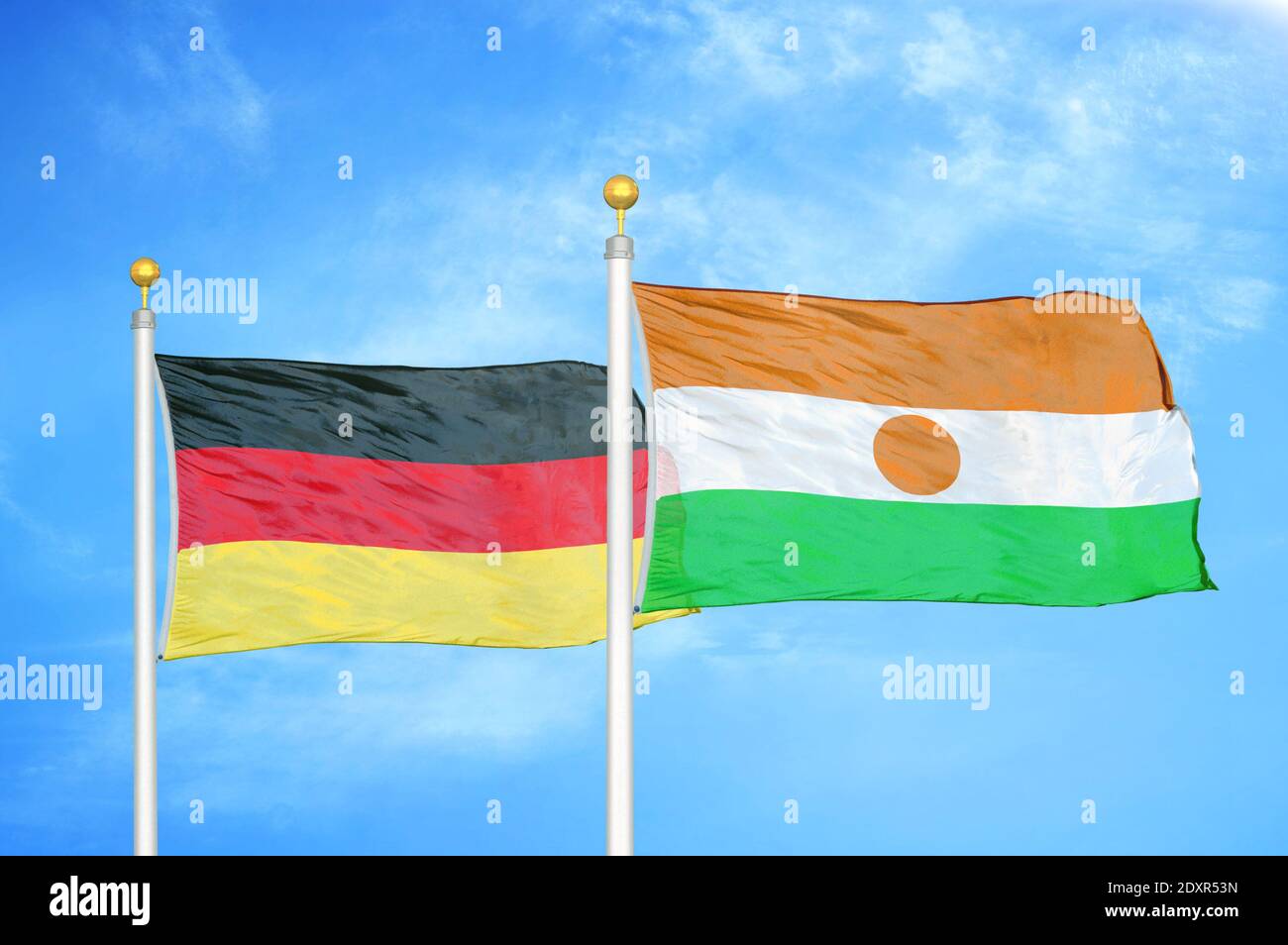 Germany and Niger two flags on flagpoles and blue cloudy sky Stock ...