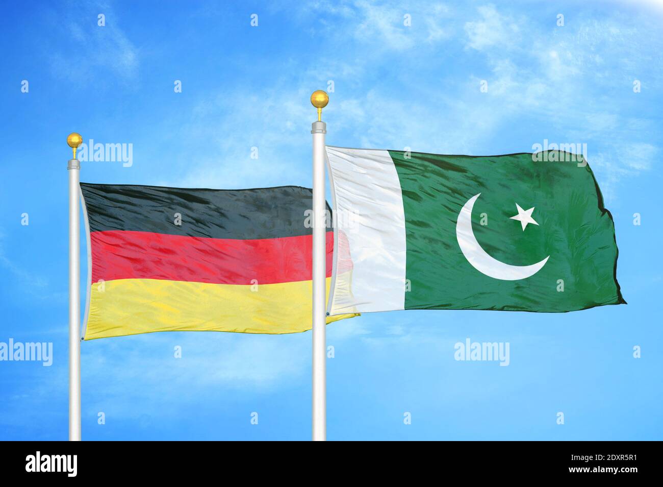 Germany and Pakistan two flags on flagpoles and blue cloudy sky Stock ...