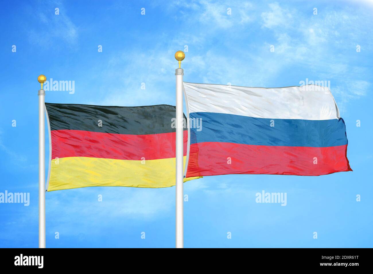 Germany and Russia two flags on flagpoles and blue cloudy sky Stock ...