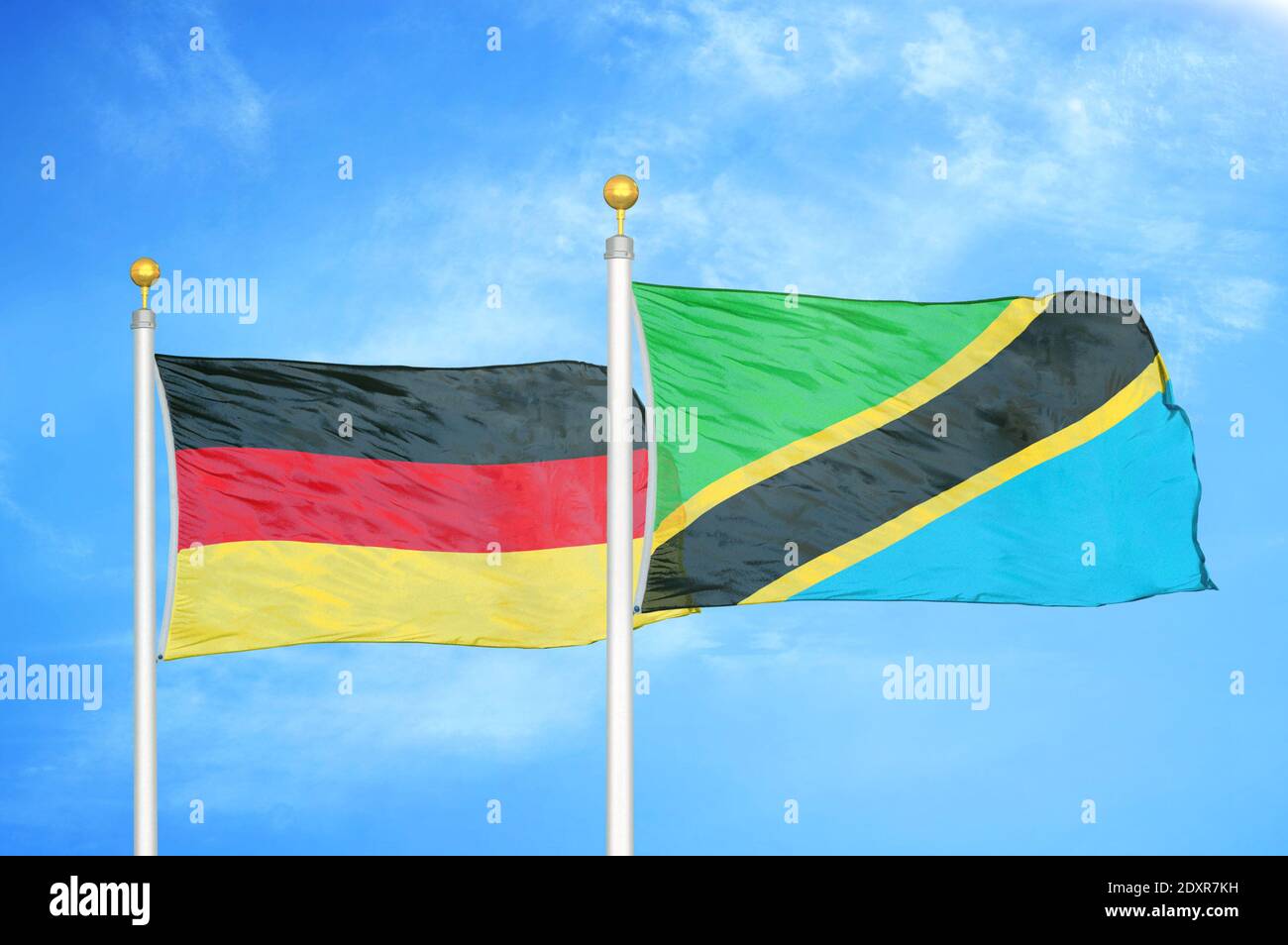 Germany and Tanzania two flags on flagpoles and blue cloudy sky Stock ...