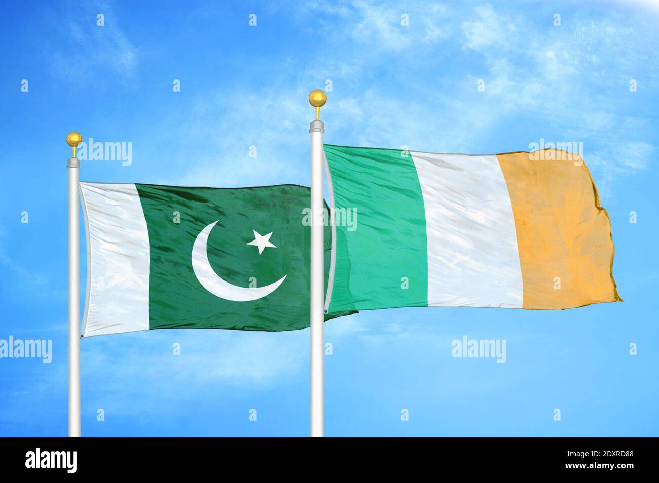 Pakistan and Ireland two flags on flagpoles and blue cloudy sky Stock ...