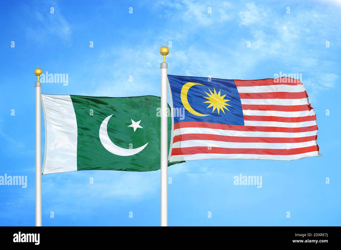 Pakistan and Malaysia two flags on flagpoles and blue cloudy sky Stock ...
