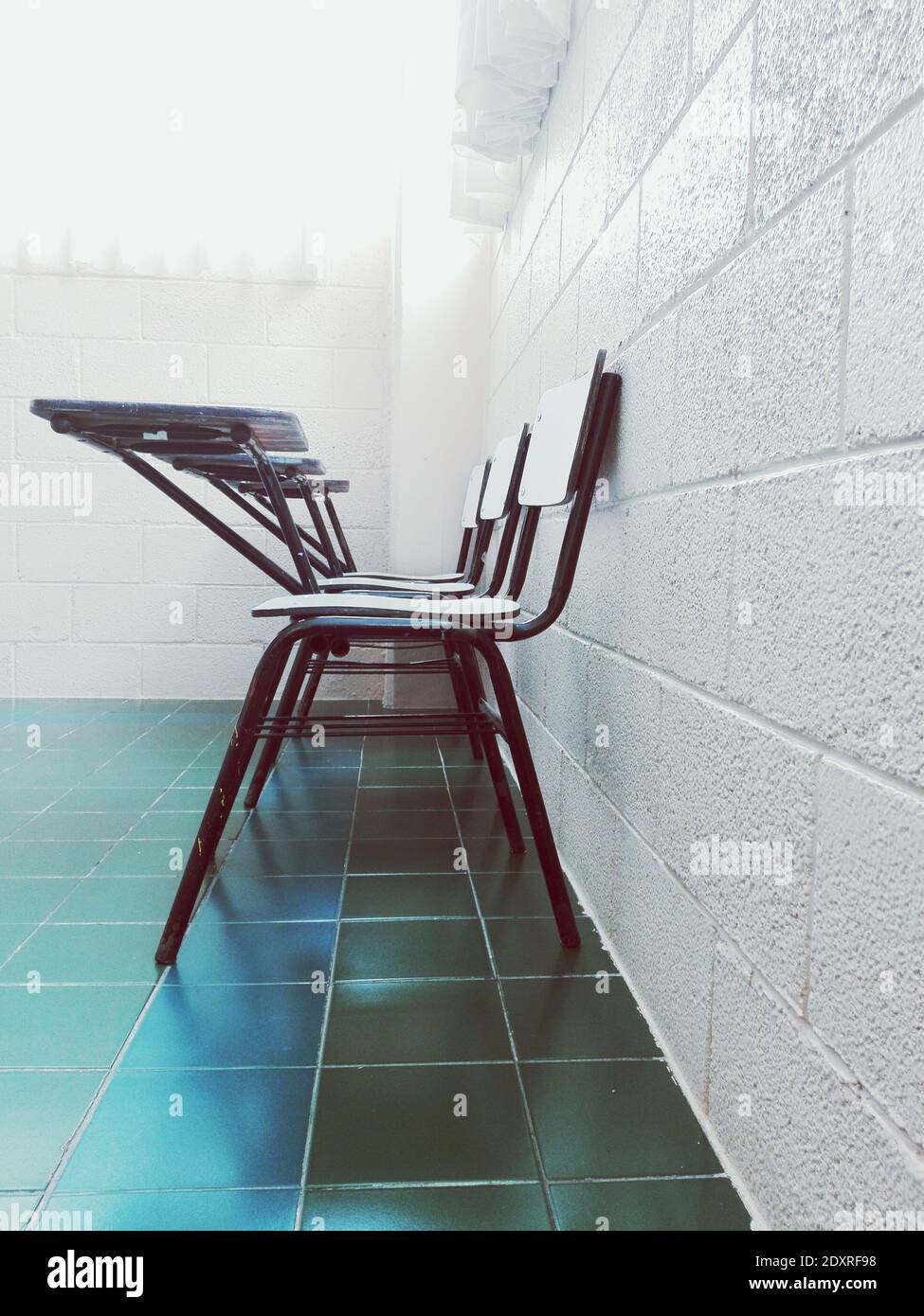 Chairs On Floor By Wall Stock Photo - Alamy