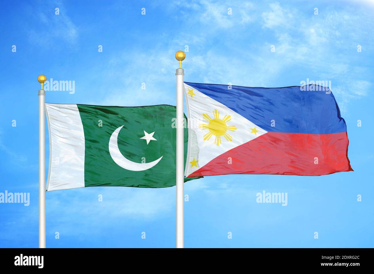 Pakistan and Philippines two flags on flagpoles and blue cloudy sky ...