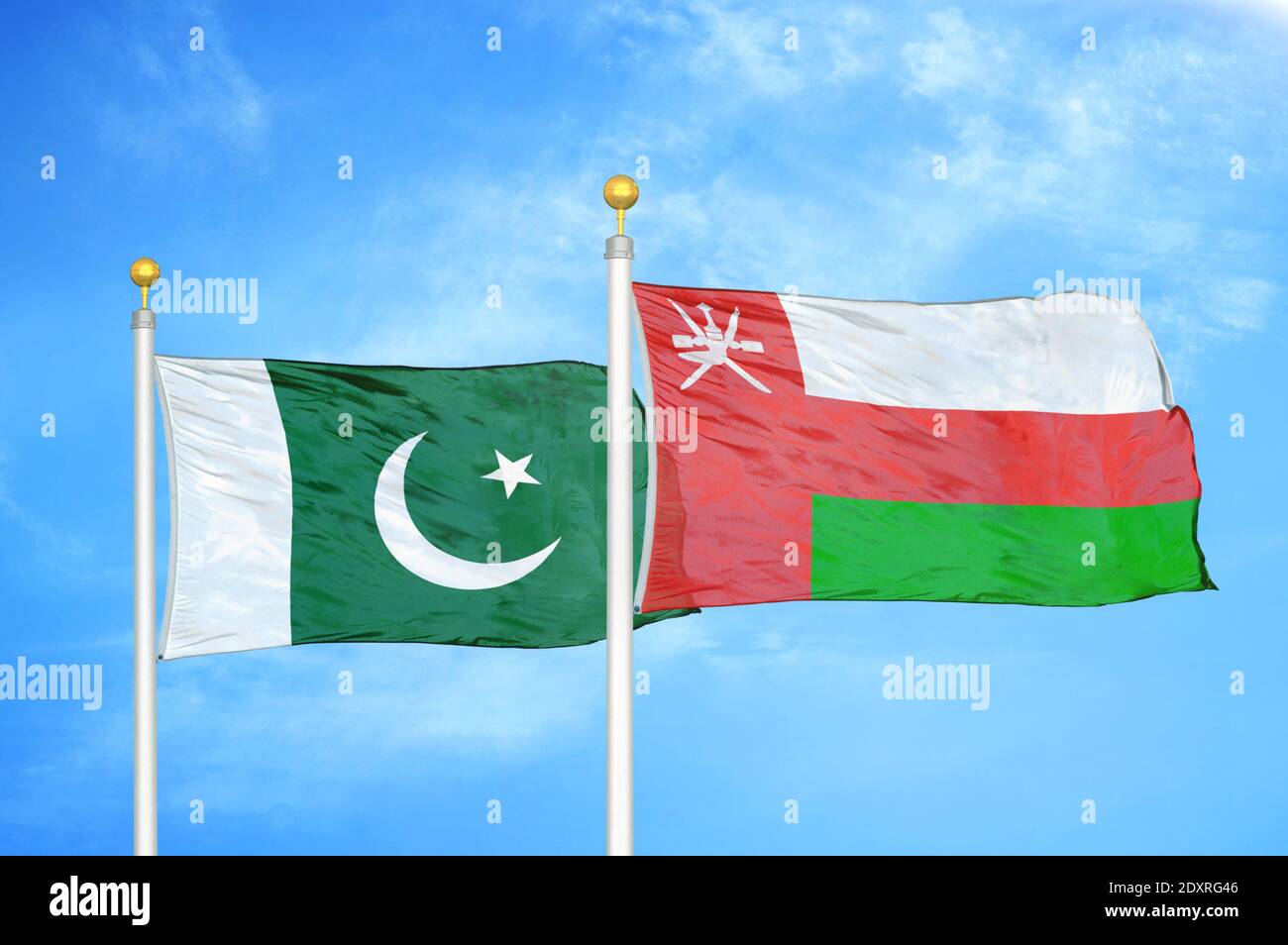 Pakistan and Oman two flags on flagpoles and blue cloudy sky Stock ...