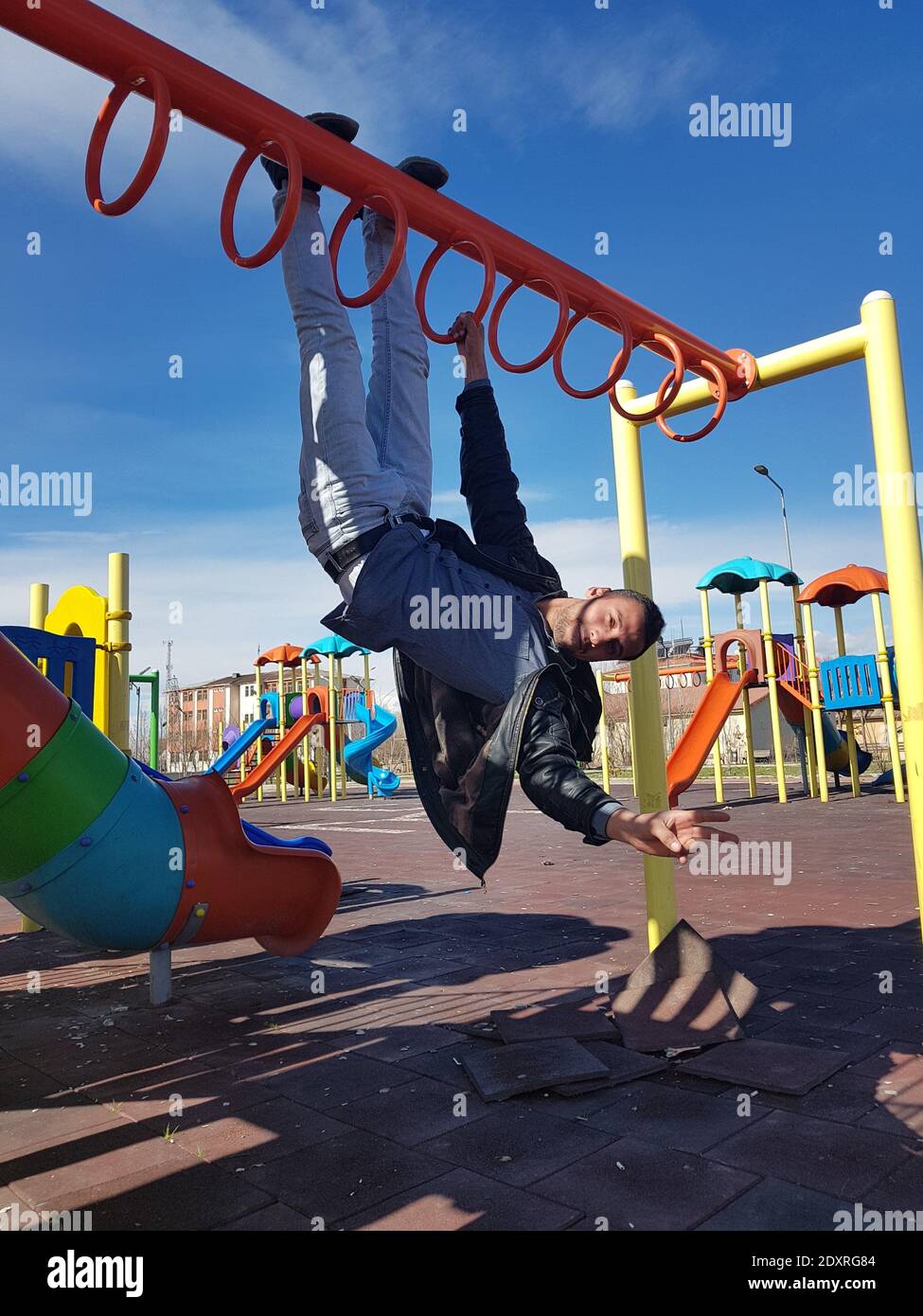 Man monkey bars playground hi-res stock photography and images - Alamy