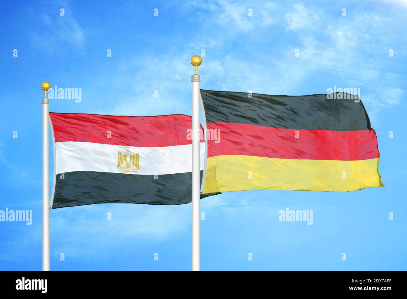 Egypt and Germany two flags on flagpoles and blue cloudy sky Stock ...