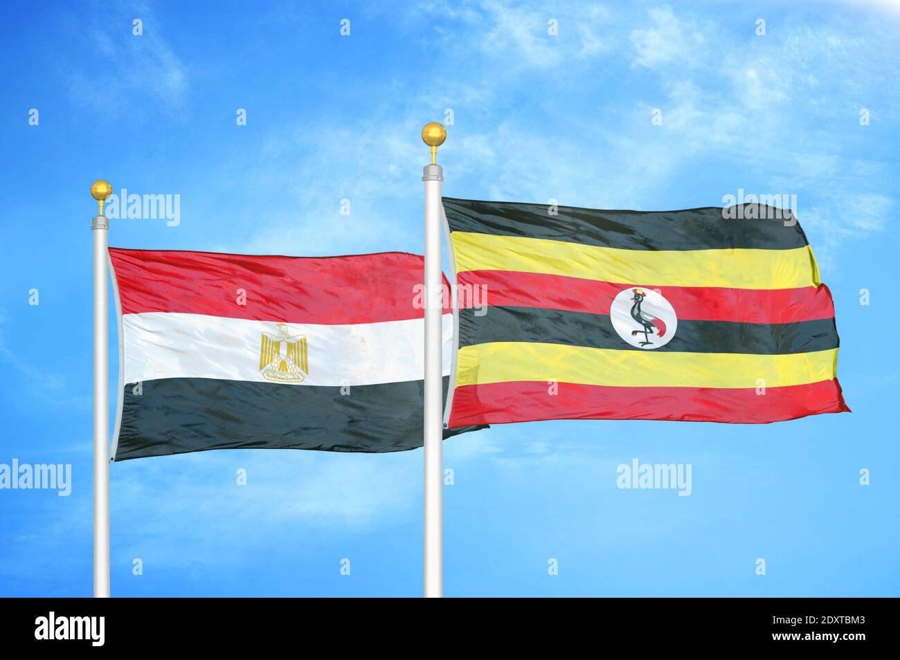 Egypt and Uganda two flags on flagpoles and blue cloudy sky Stock Photo ...