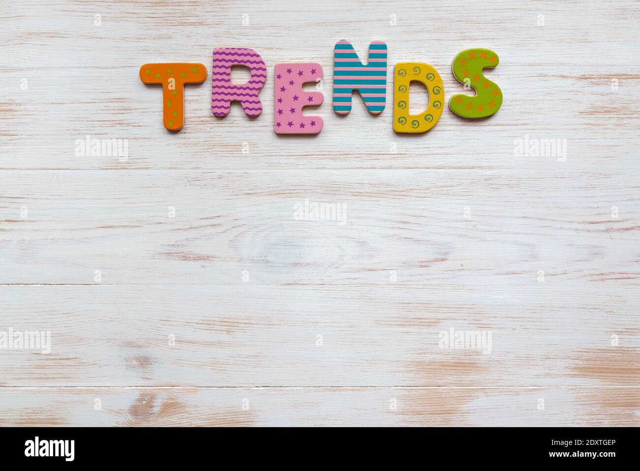 Word TRENDS on wooden board. Multicolor letters, text message for card ...