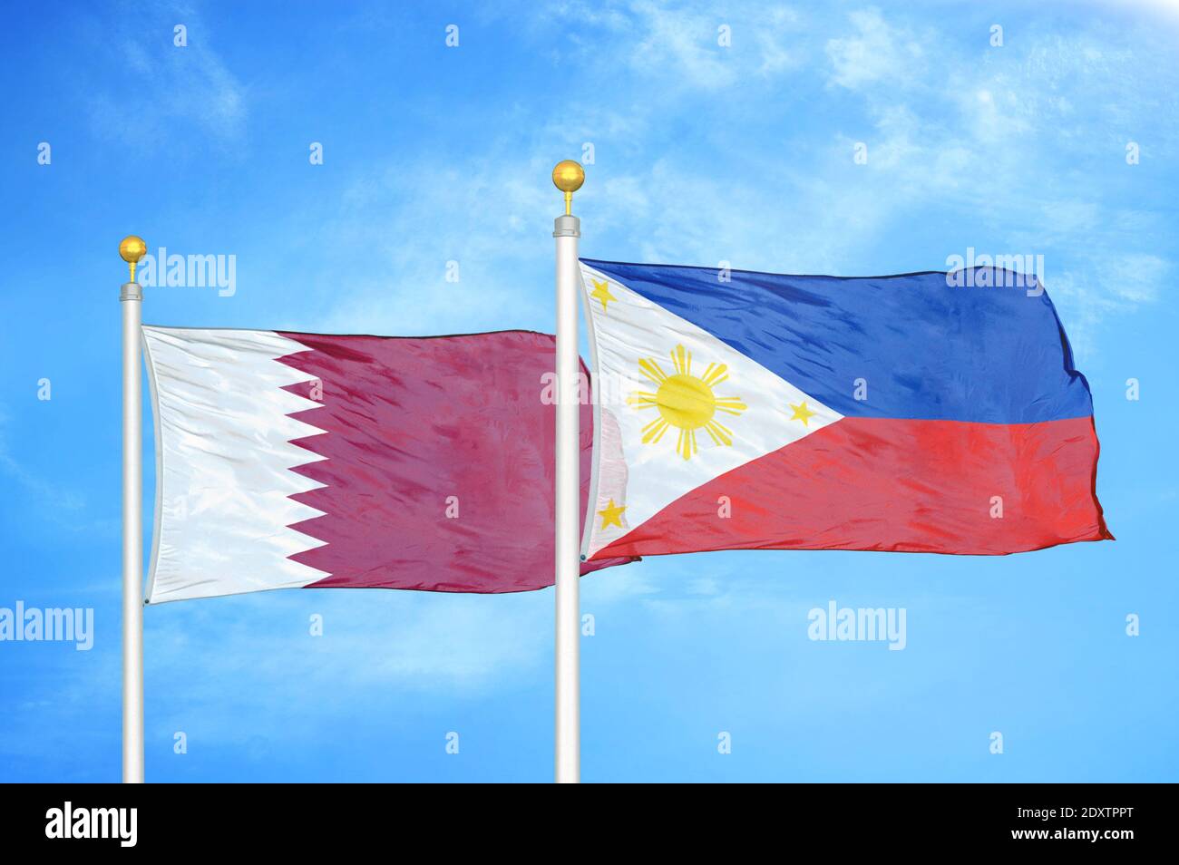 Qatar and Philippines two flags on flagpoles and blue cloudy sky Stock ...