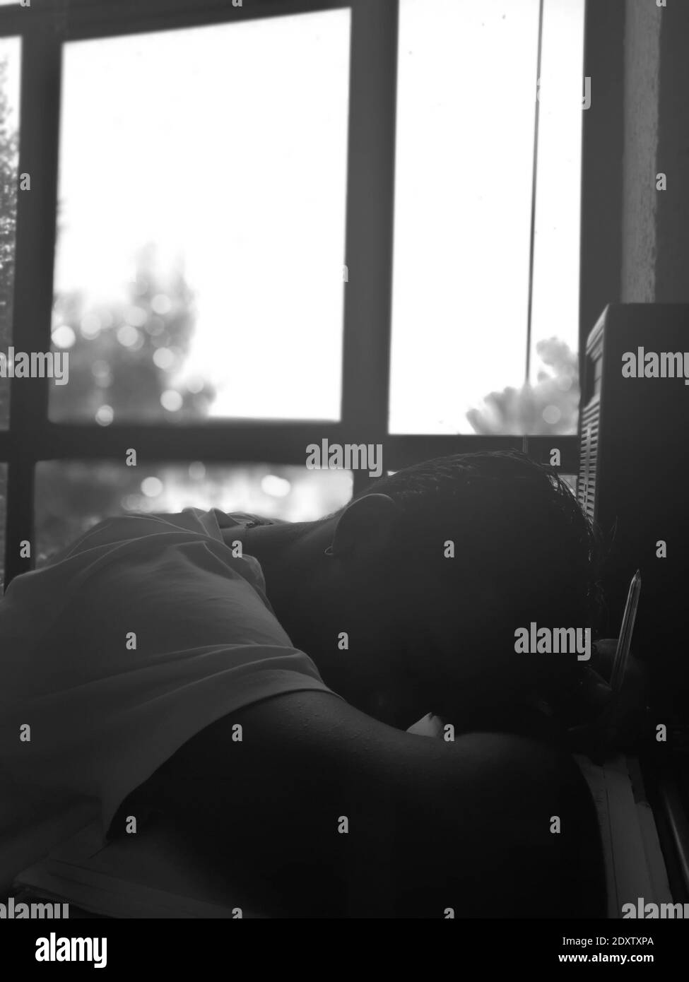 Resting head on table Black and White Stock Photos & Images - Alamy
