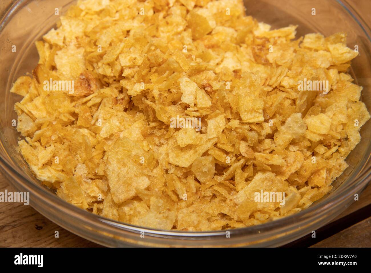 A bowl of crunched potato chips, crisps used for cooking Stock Photo ...
