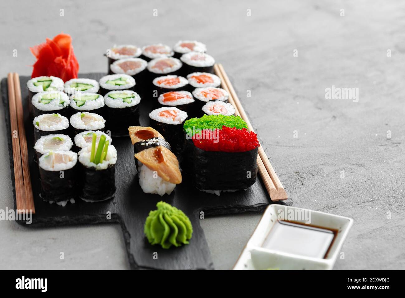 Maki sushi set served on black stone tray Stock Photo - Alamy