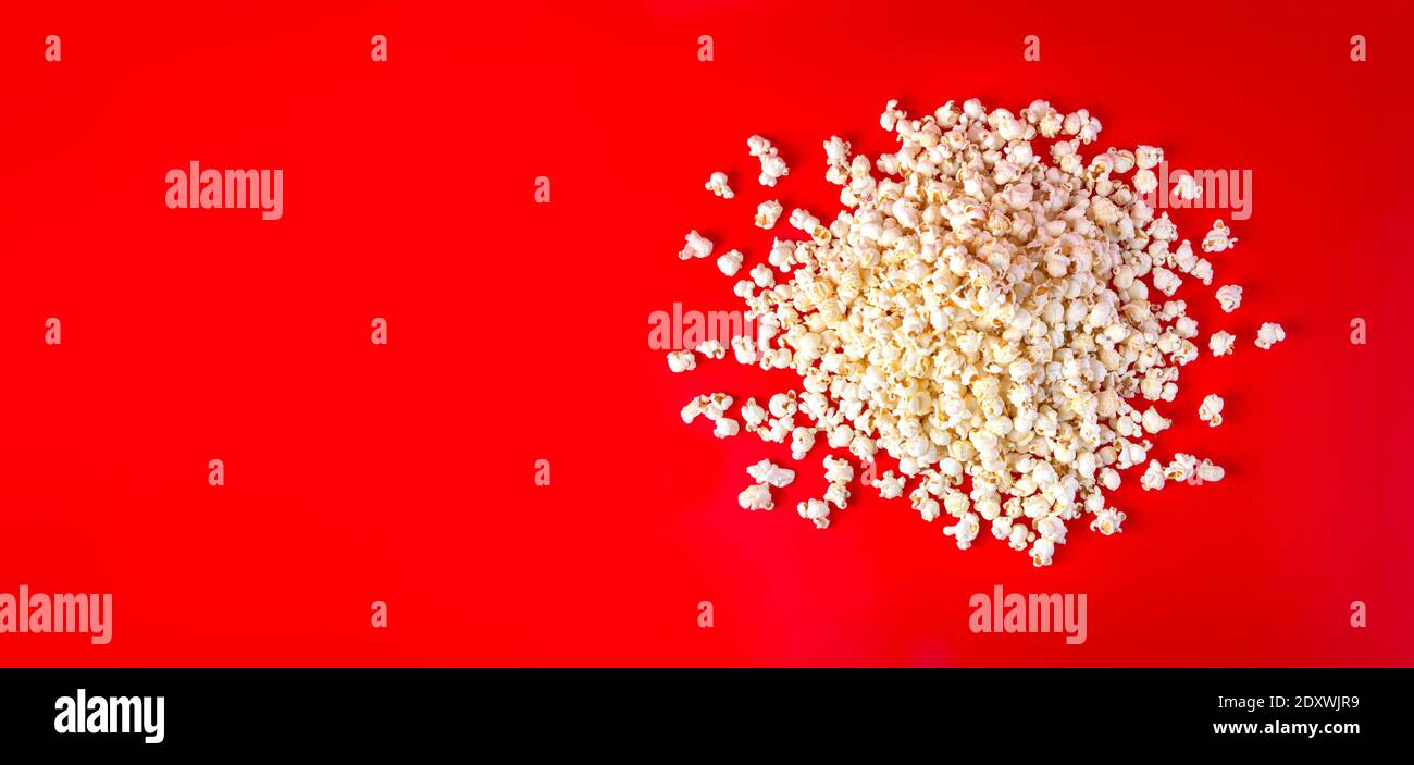 Spilled popcorn on a red background, cinema, movies and entertainment ...