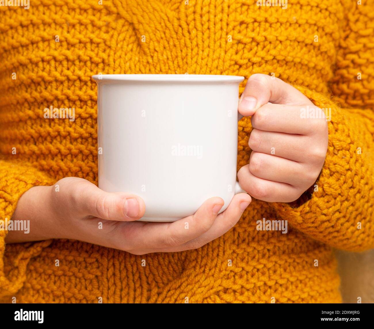 Girl is holding white cup in hands. Mockup for designs Stock Photo - Alamy