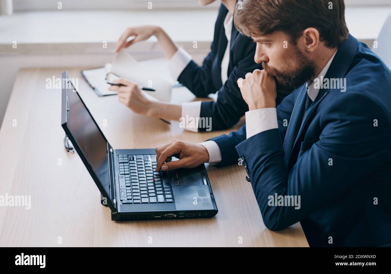 Work colleagues in suits working desk laptop office managers team Stock ...