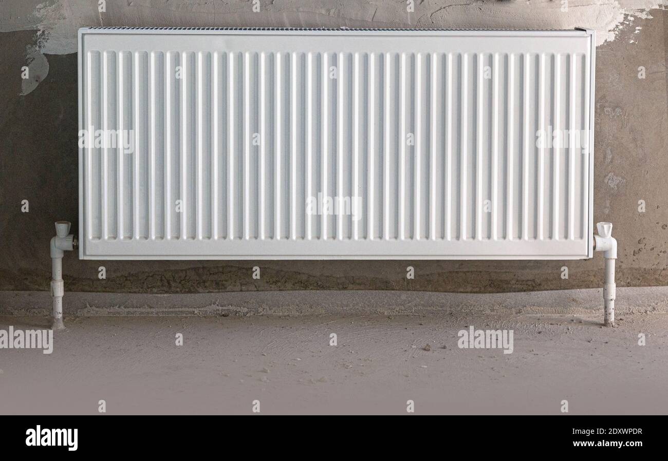 radiator with piped heating pipes in a new apartment under construction ...