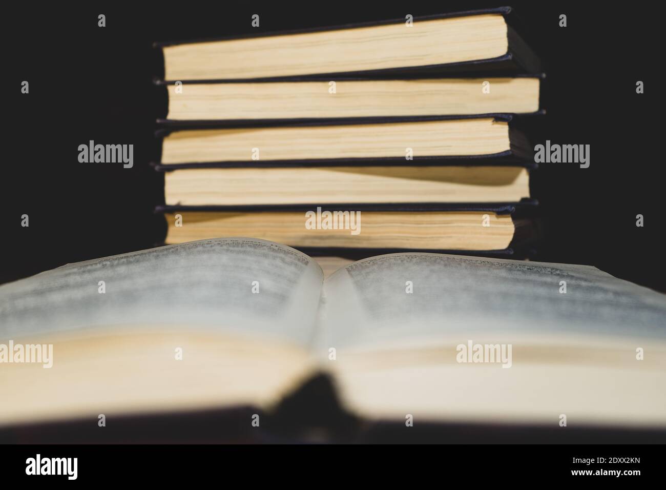 An open book on the background of a stack of books. Reading a book ...