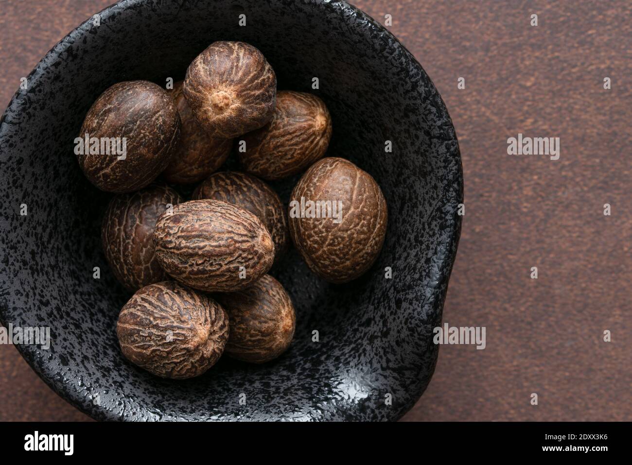 Whole Nutmeg in a Bowl Stock Photo - Alamy