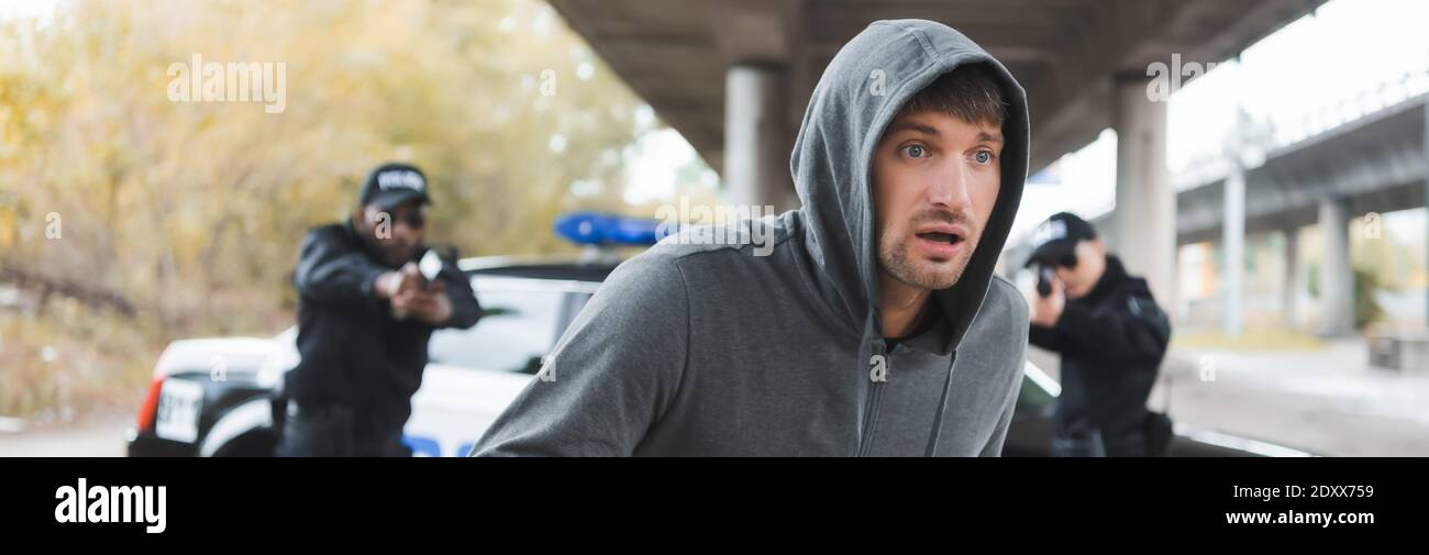 scared hooded offender running from multicultural police officers on ...