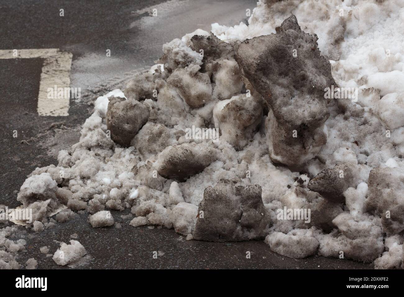 a huge pile of dirty snow on a new york city curb after a snowstorm ...