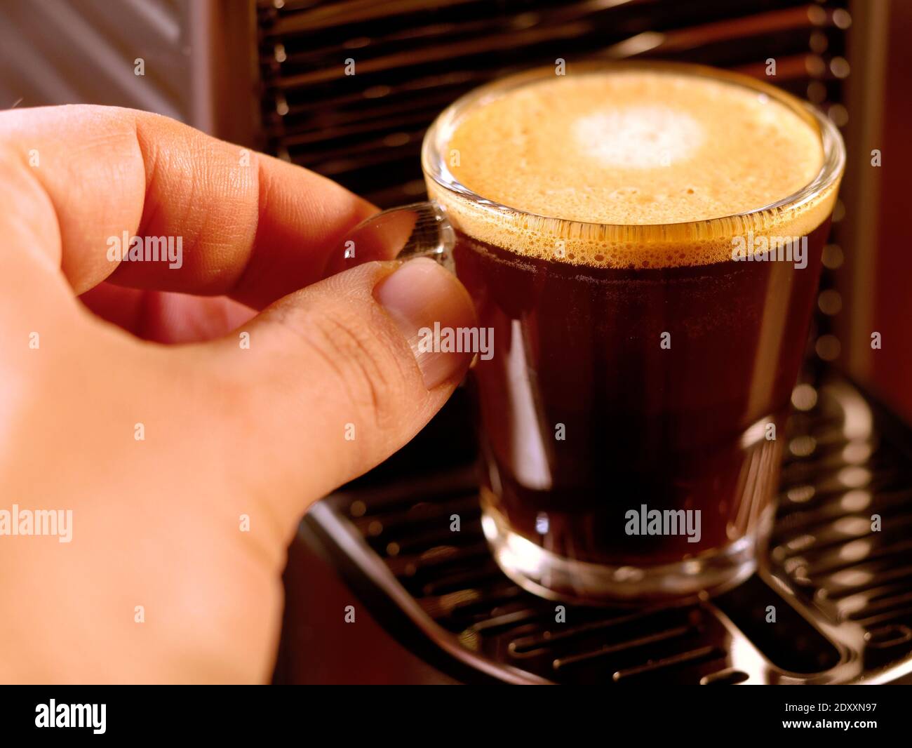 hand grabbing glass of coffee espresso machine closeup Stock Photo - Alamy