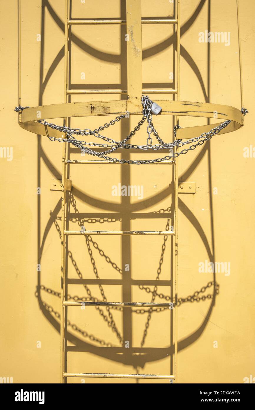 A vertical shot of a fire escape ladder Stock Photo - Alamy