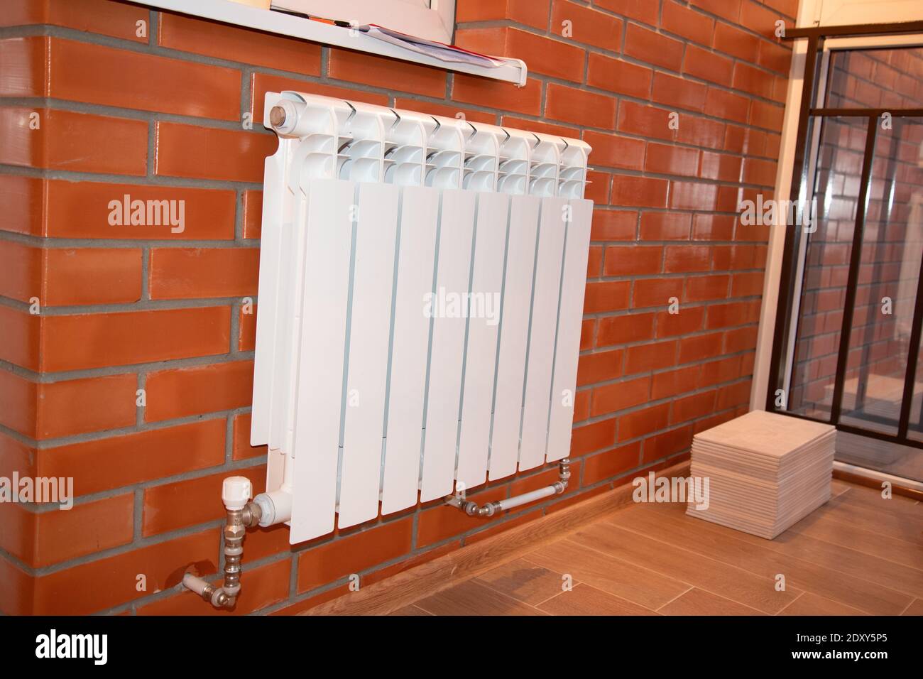 white home heating radiator on brick wall Stock Photo - Alamy