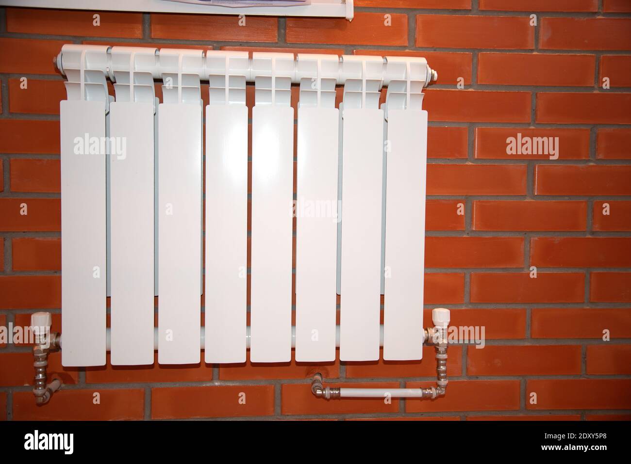 white home heating radiator on brick wall Stock Photo - Alamy