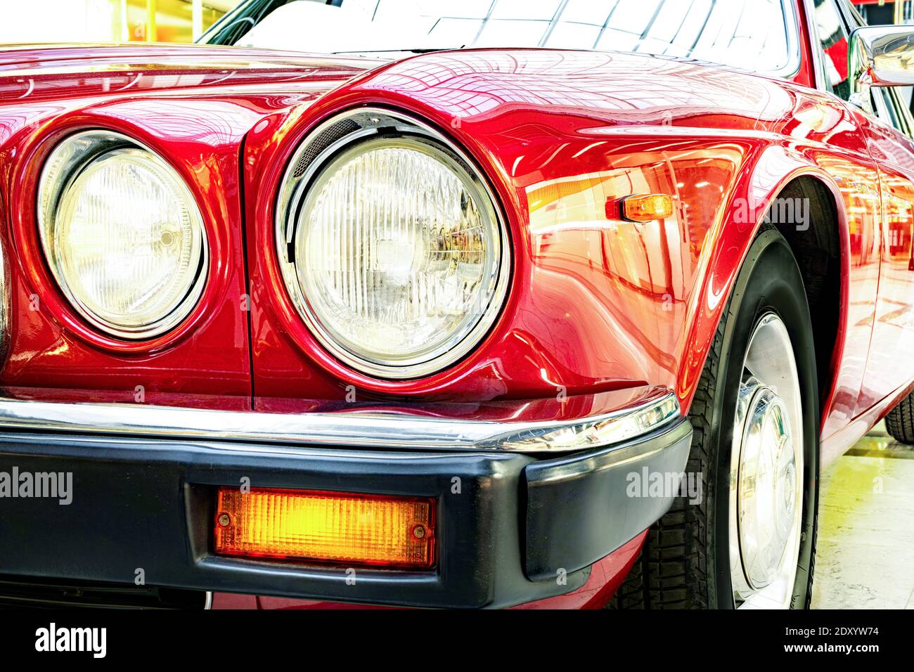 A closeup of the headlight and front bumper on a vintage car Stock ...