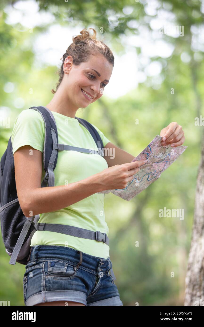 portrait of female hiker looking at map Stock Photo - Alamy