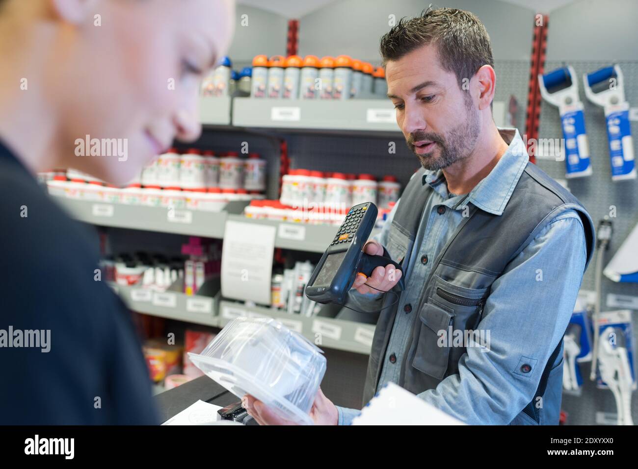 hardware store salesman worker with barcode scanner Stock Photo - Alamy