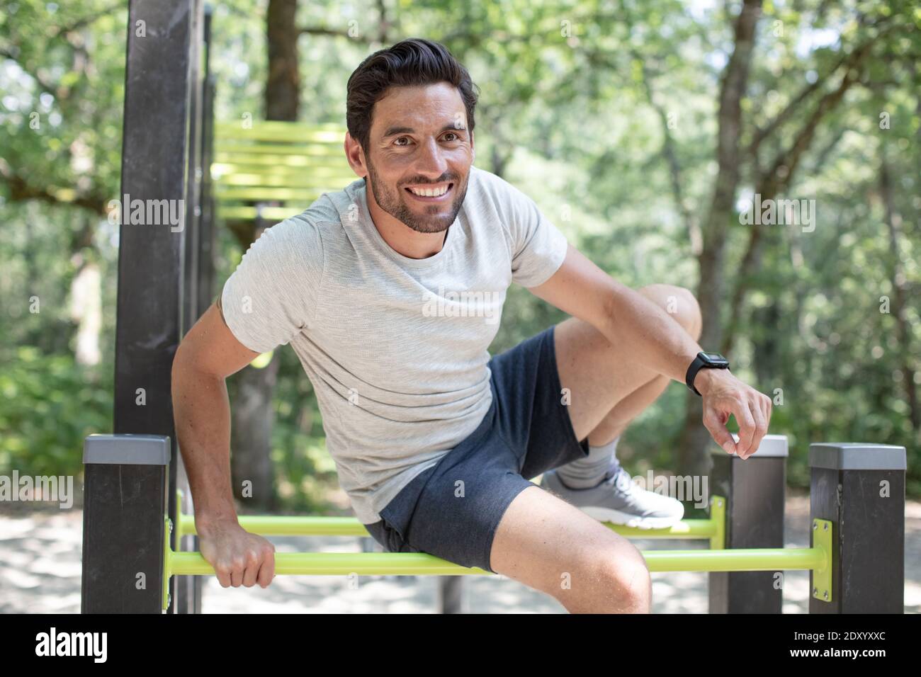 fit man workout out arms on dips horizontal bars Stock Photo - Alamy