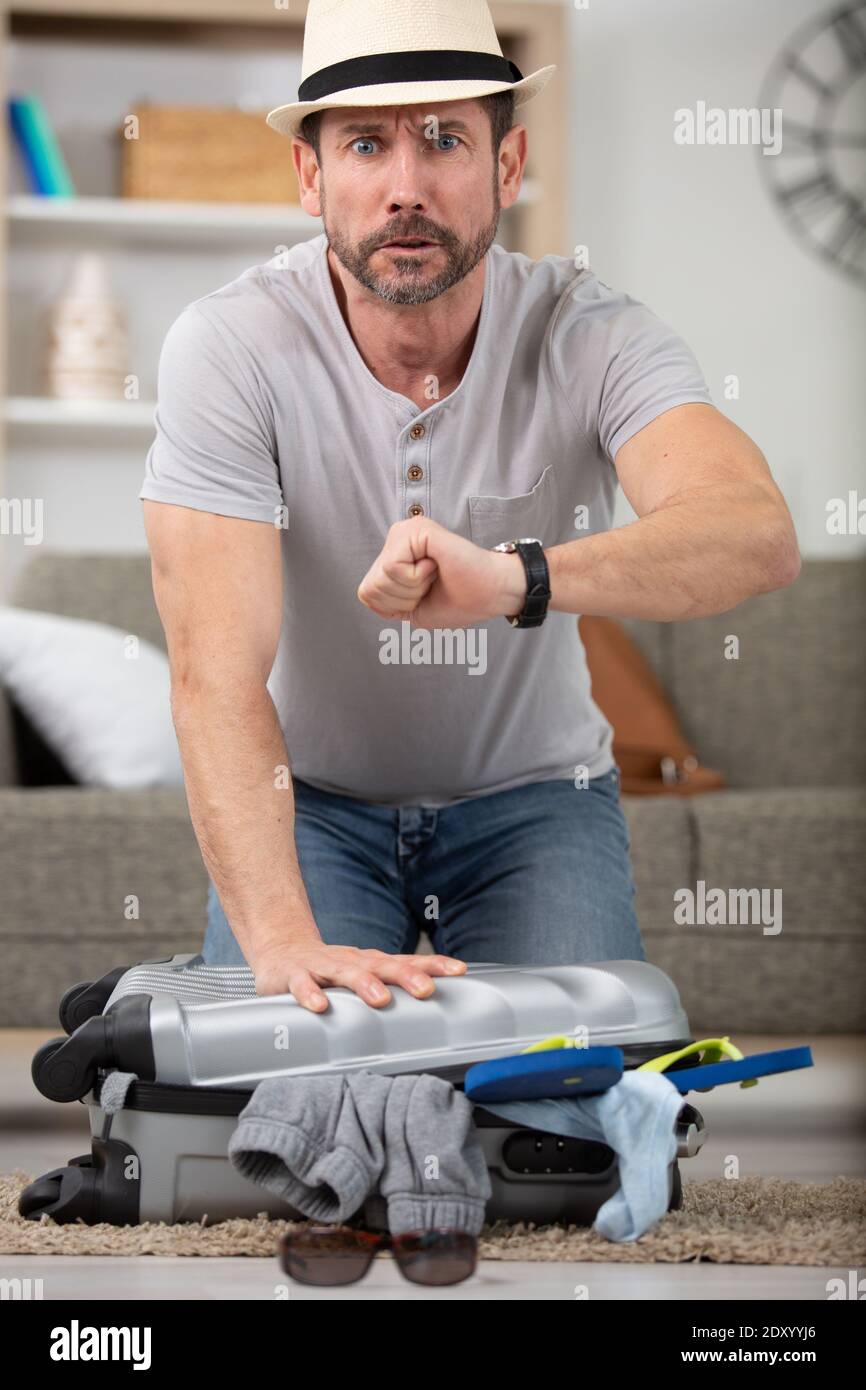 late man preparing packing for business trip looking his watch Stock ...