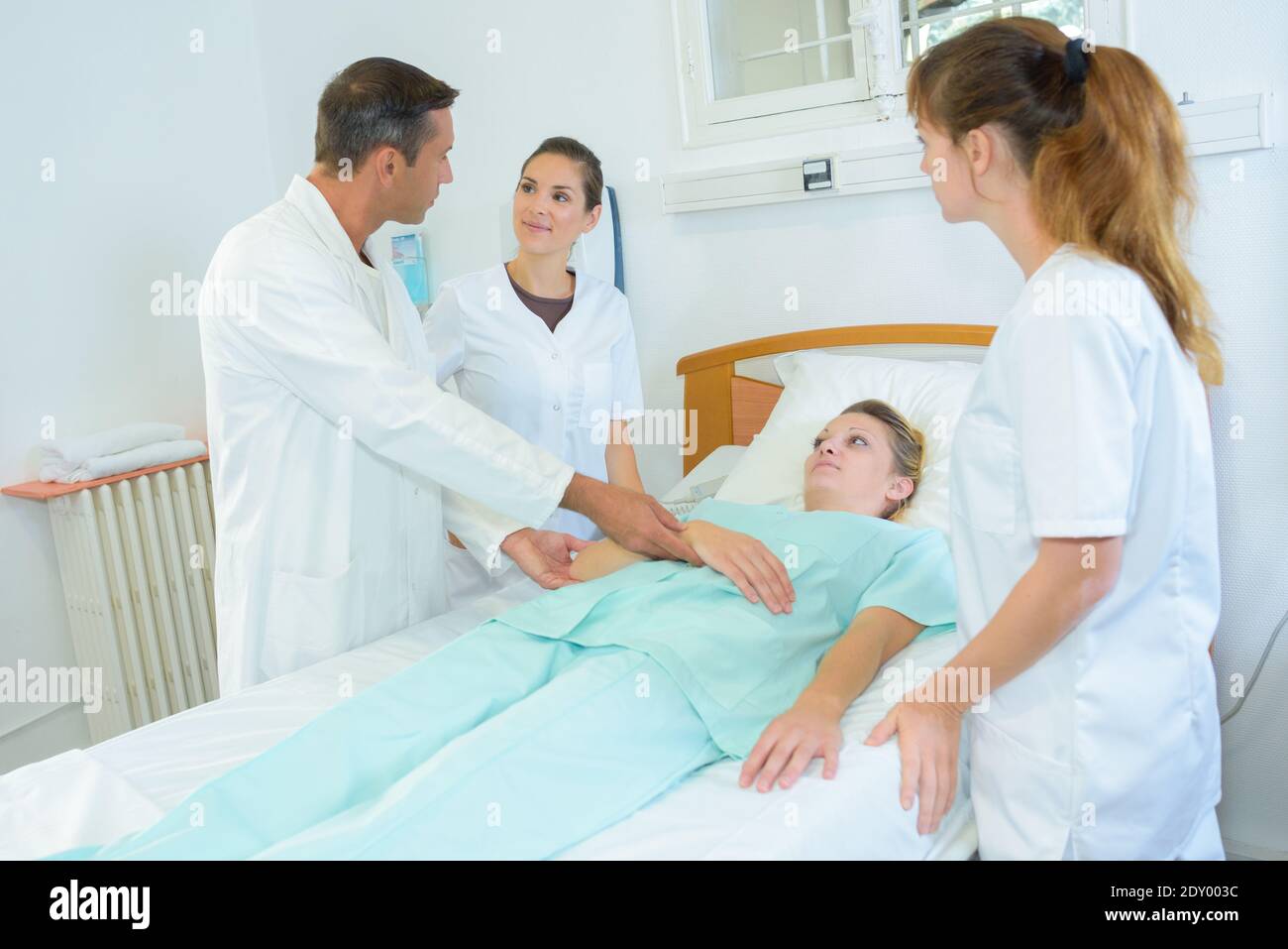 nurses practicing how to roll a patient Stock Photo - Alamy