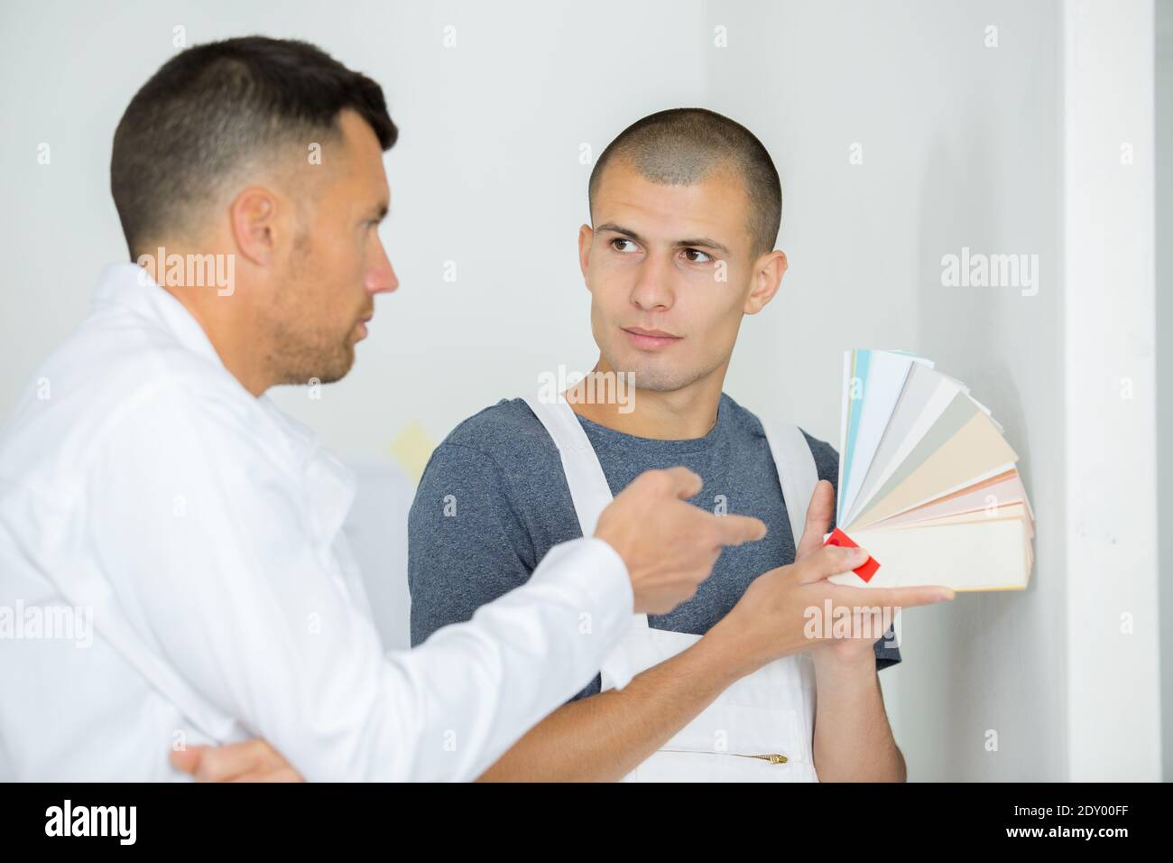 painter men choosing colour swatches Stock Photo - Alamy