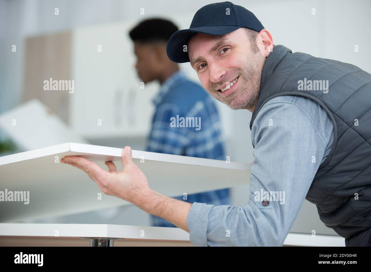 two men assembling a kitchen cupboard Stock Photo - Alamy