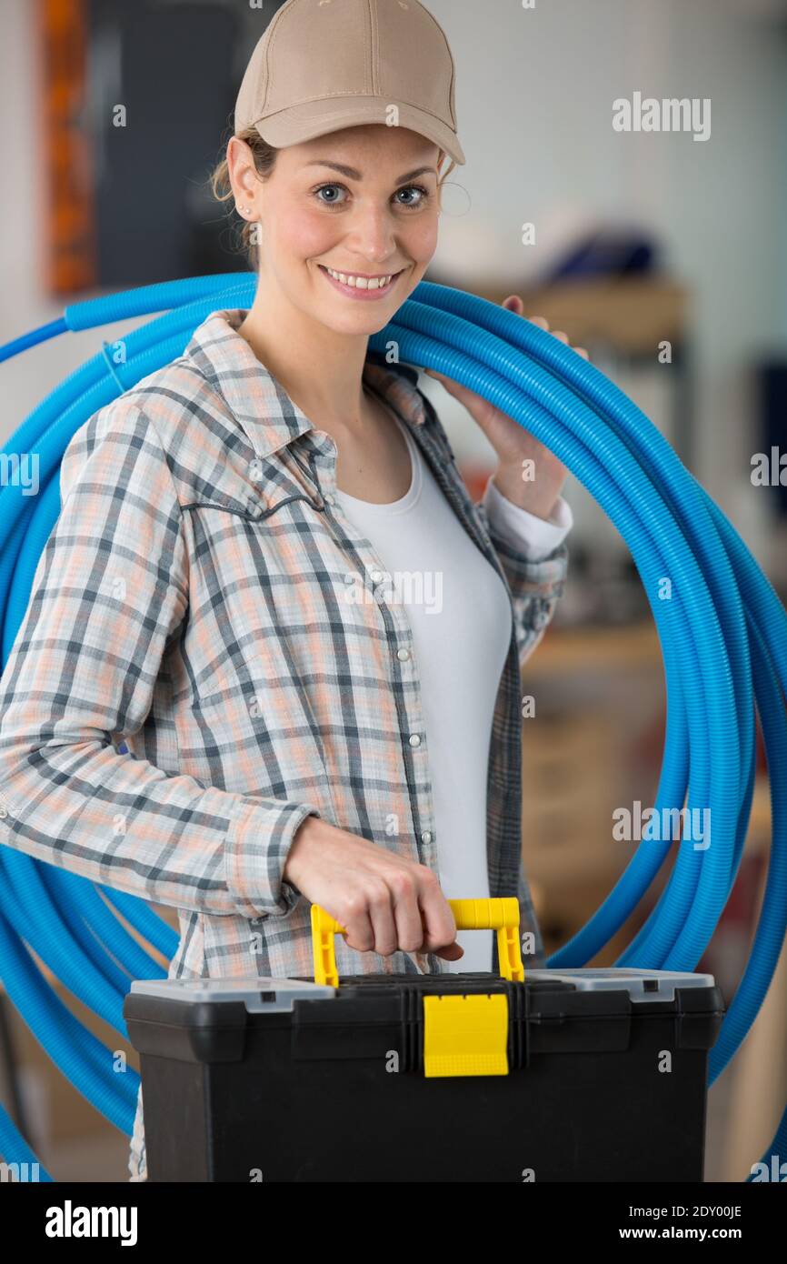 female plumber carrying equipment and toolbox Stock Photo - Alamy