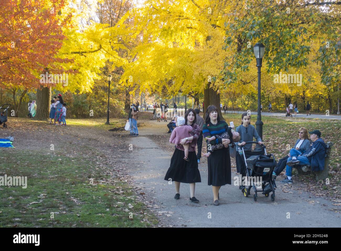 People enjoy a warm autumn day amidst the fall colors is Prospect Park ...