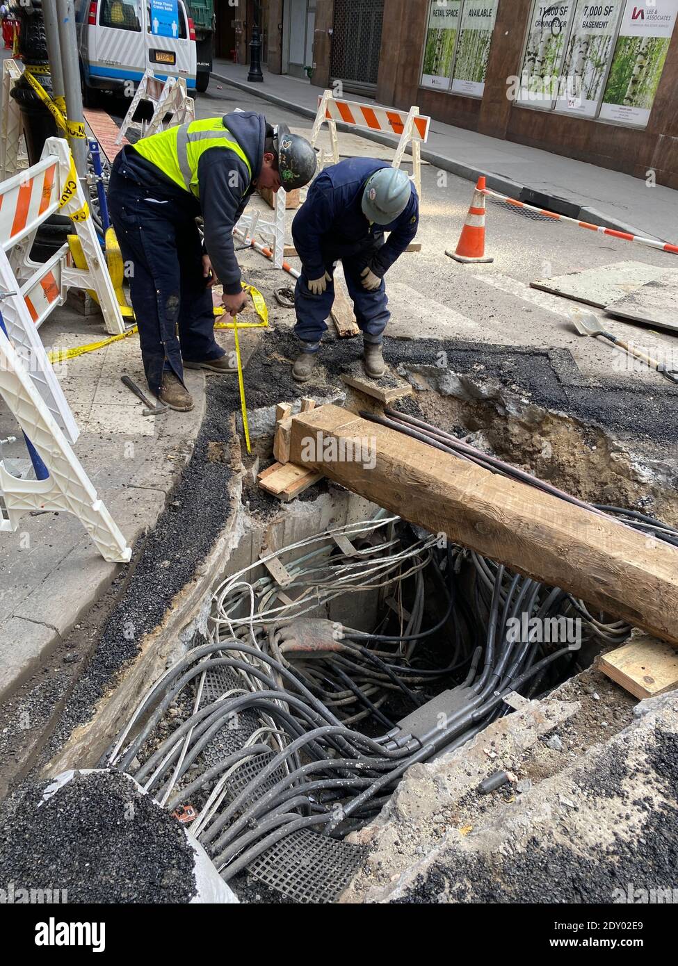 Men work under the street on the complex entanglement of electrical ...