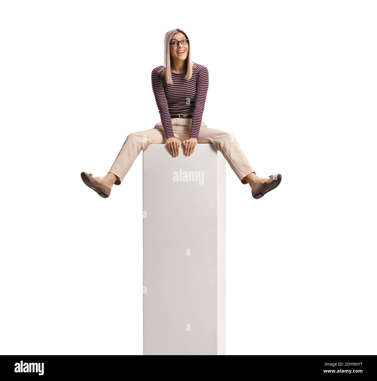 Cheeful young woman sitting on a white column bar isolated on white ...