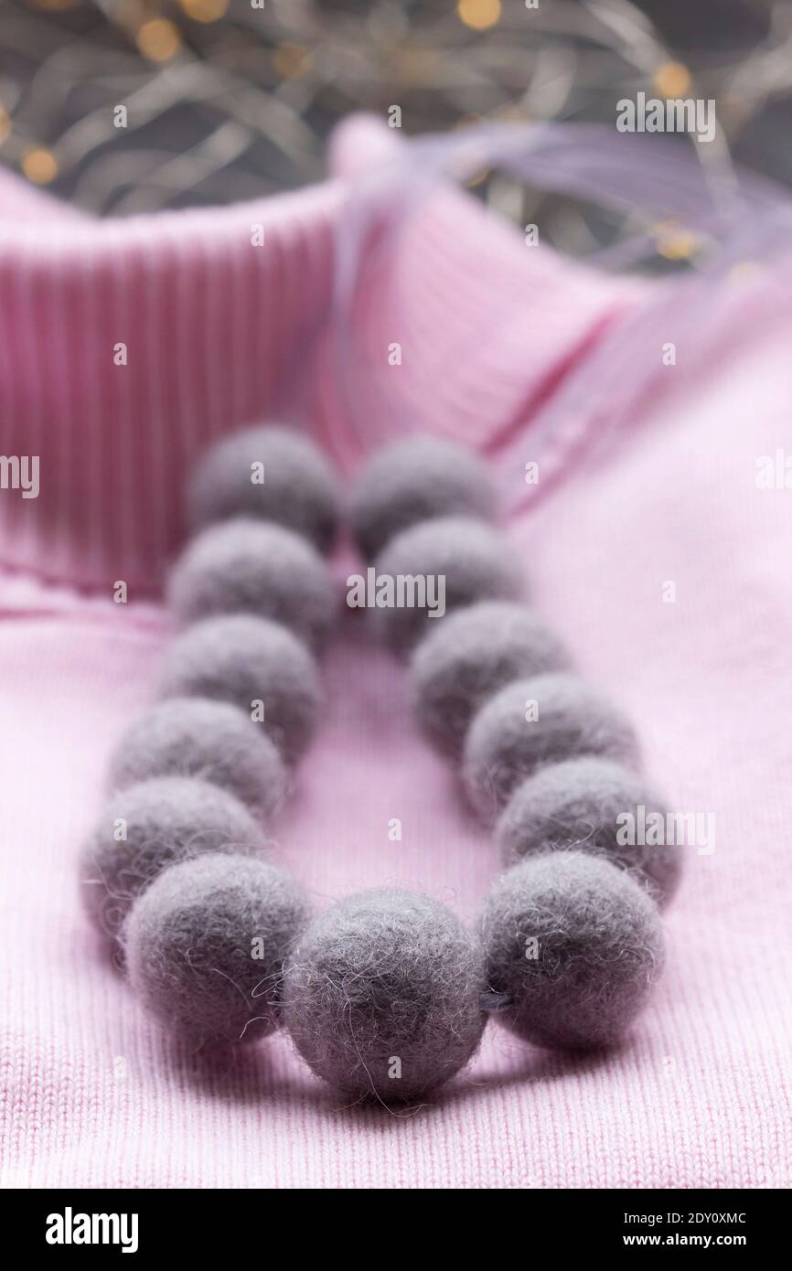 Handmade wool necklace on the background of clothes Stock Photo - Alamy
