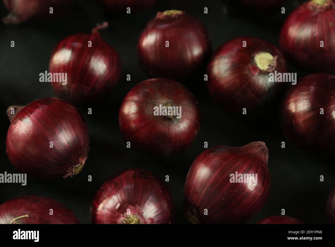 sweet red onions on background Stock Photo - Alamy