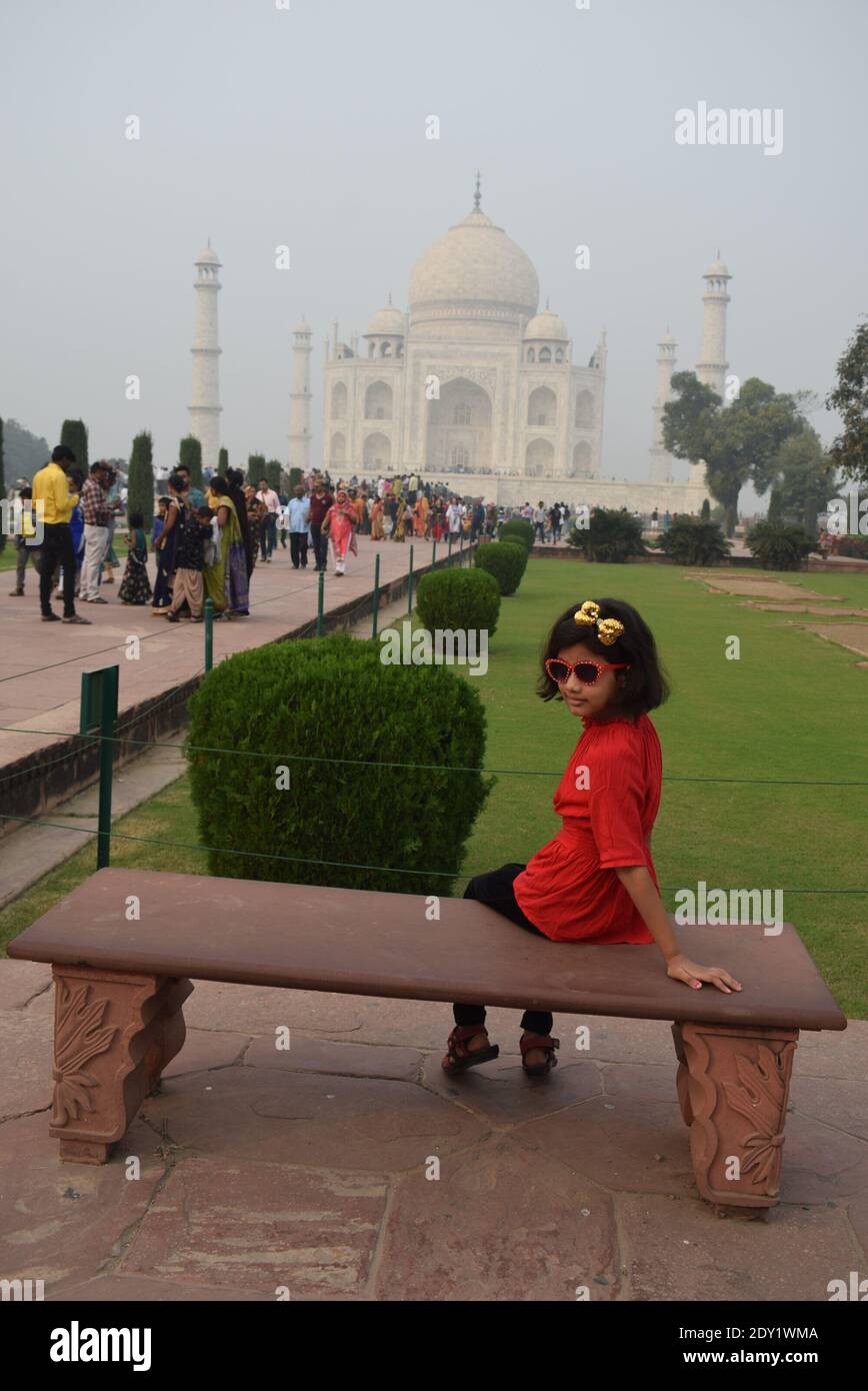 Portrait Of Cute Girl Sitting On Seat Stock Photo - Alamy